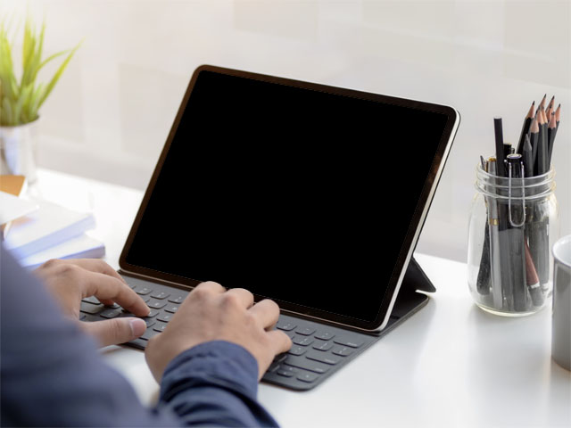 Person Working on Digital Tablet mockup | MockupsJar