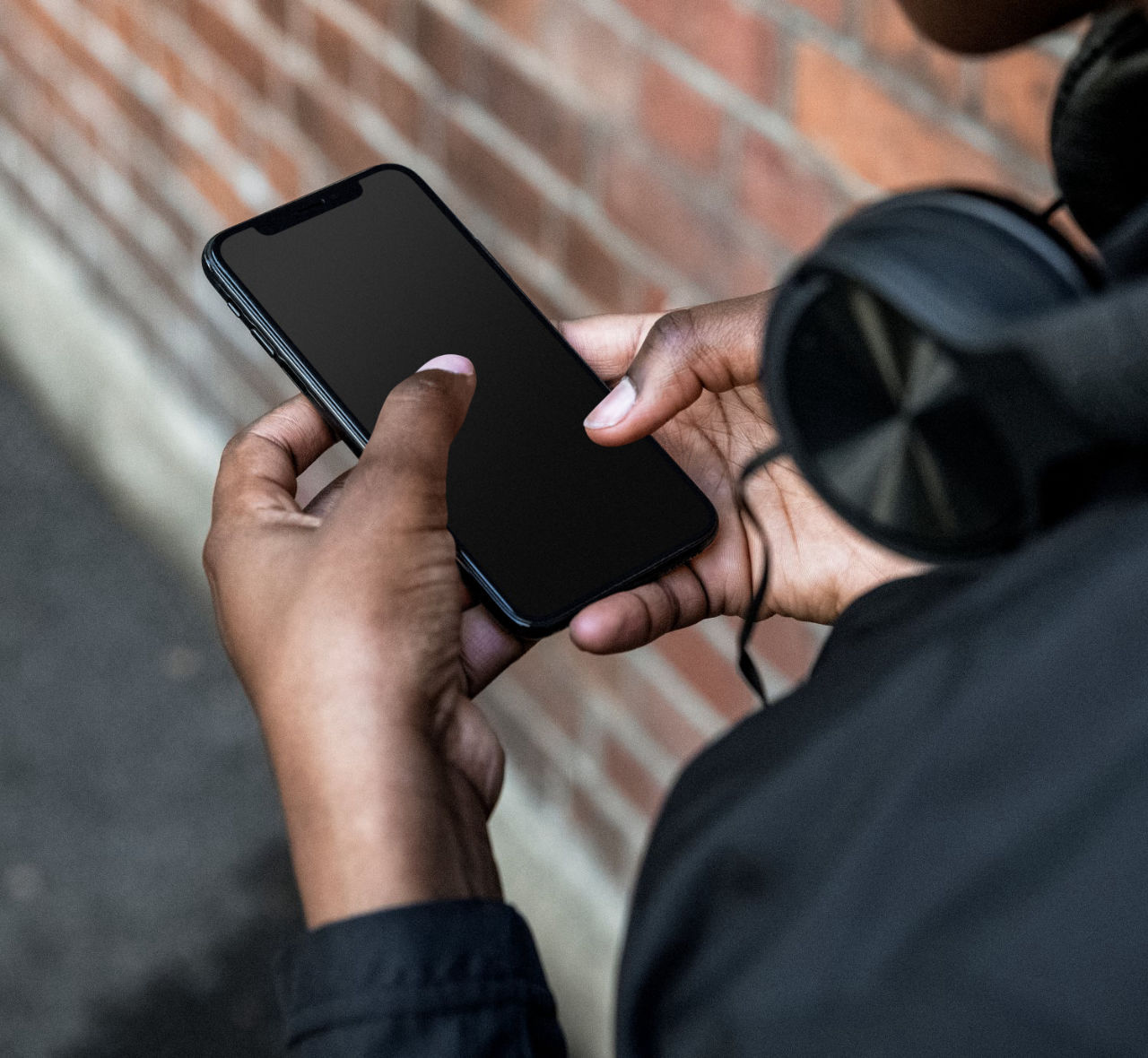 Closeup of man on iPhone X mockup | MockupsJar