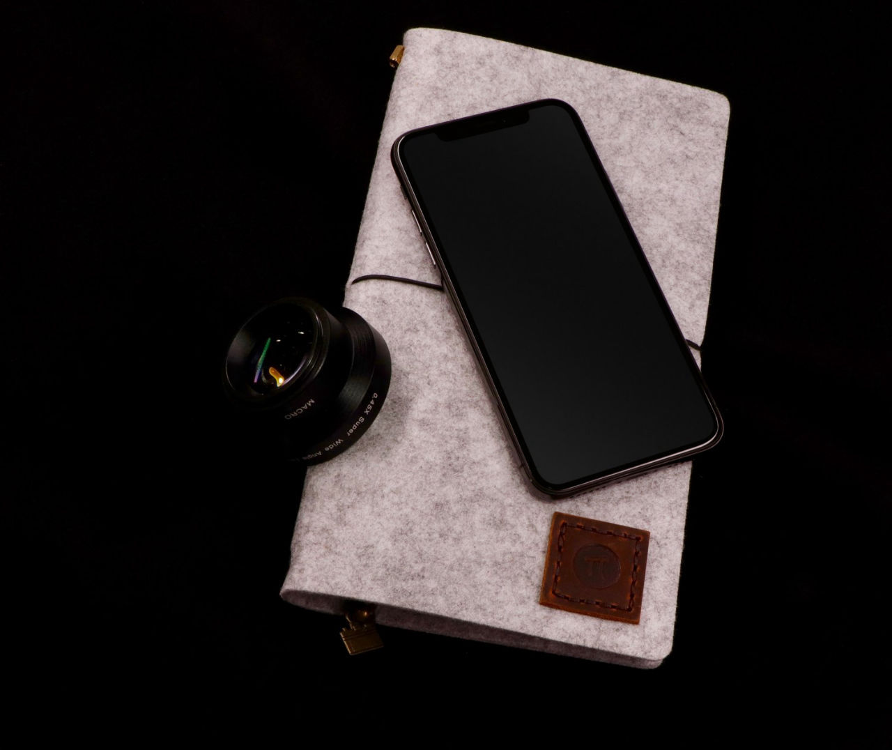 iPhone X on notebook mockup | MockupsJar