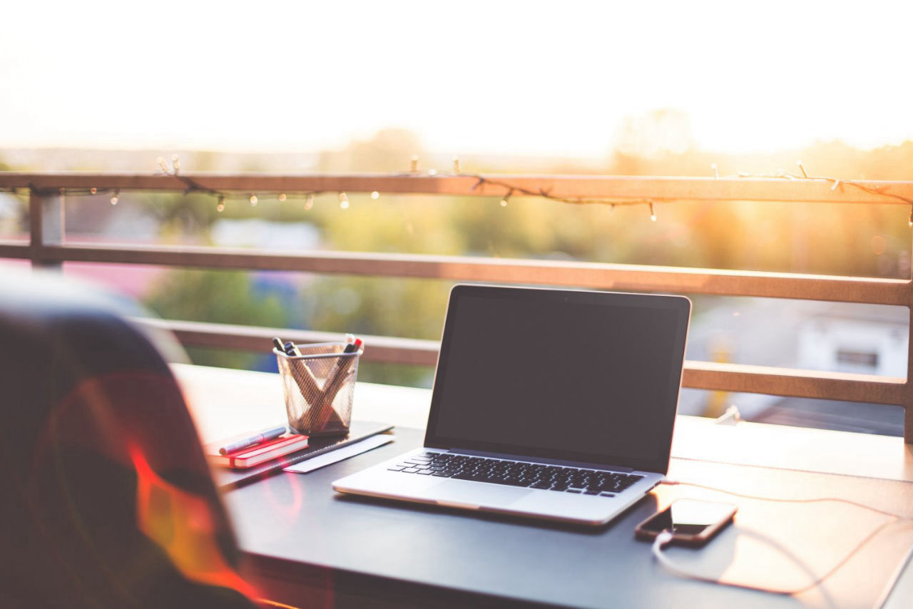 MacBook Pro on outside table mockup | MockupsJar