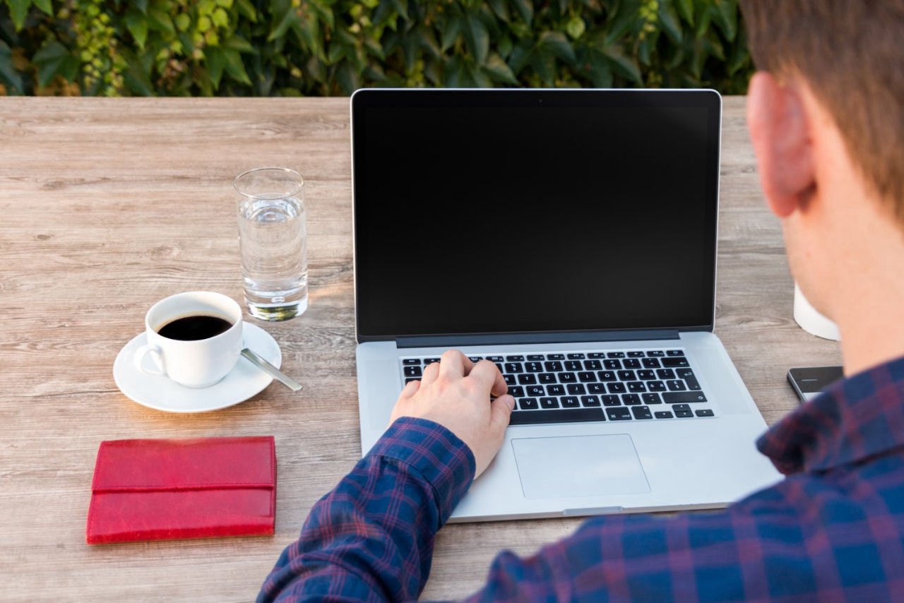 Man using 15 inch MacBook Pro mockup | MockupsJar